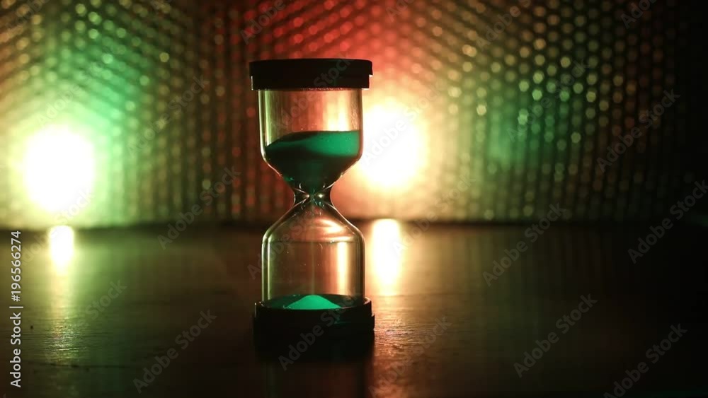 Time concept. Silhouette of Hourglass clock on dark toned backlight ...