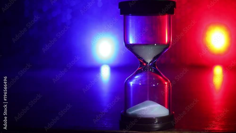 Time concept. Silhouette of Hourglass clock on dark toned backlight ...