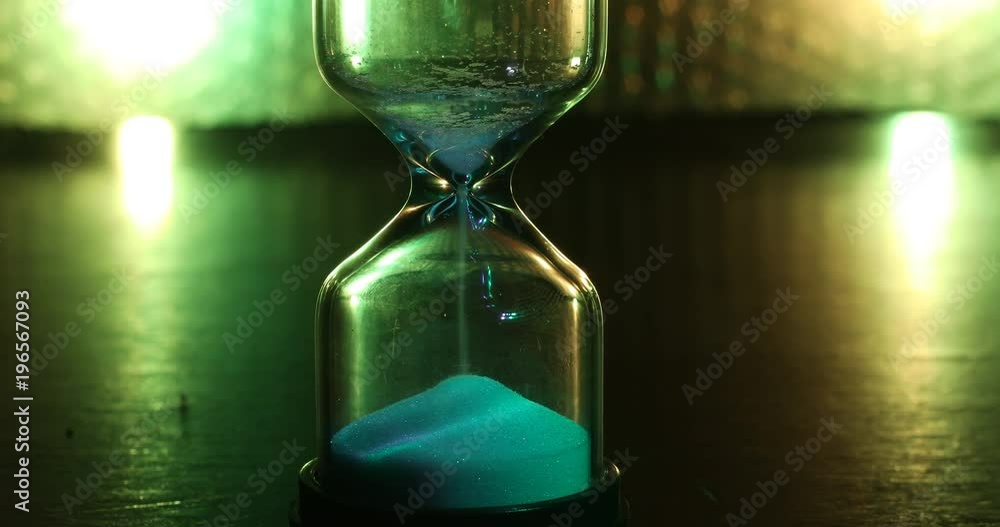 Vidéo Stock Time concept. Silhouette of Hourglass clock on dark toned ...