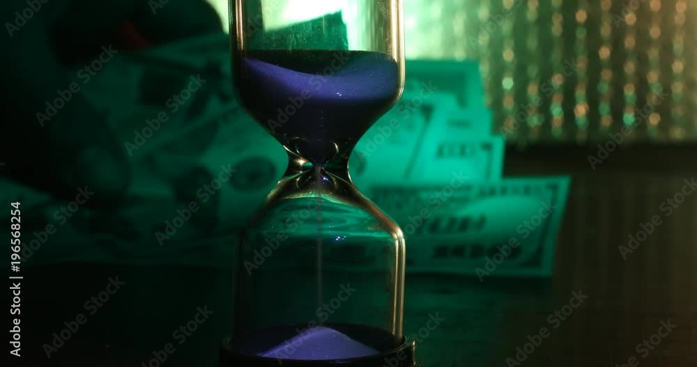 Time concept. Silhouette of Hourglass clock on dark toned backlight ...