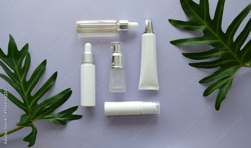 cosmetic packaging set on purple background. group of skincare cream ...