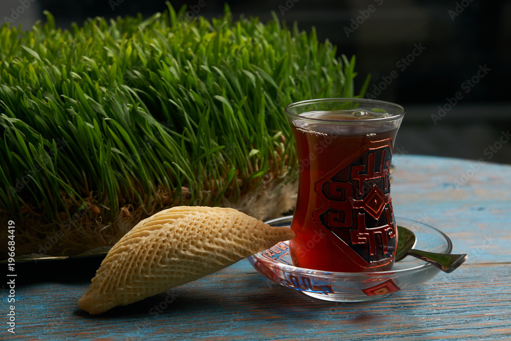 National Azerbaijan pastry shekerbura with nuts and honey and glass of ...