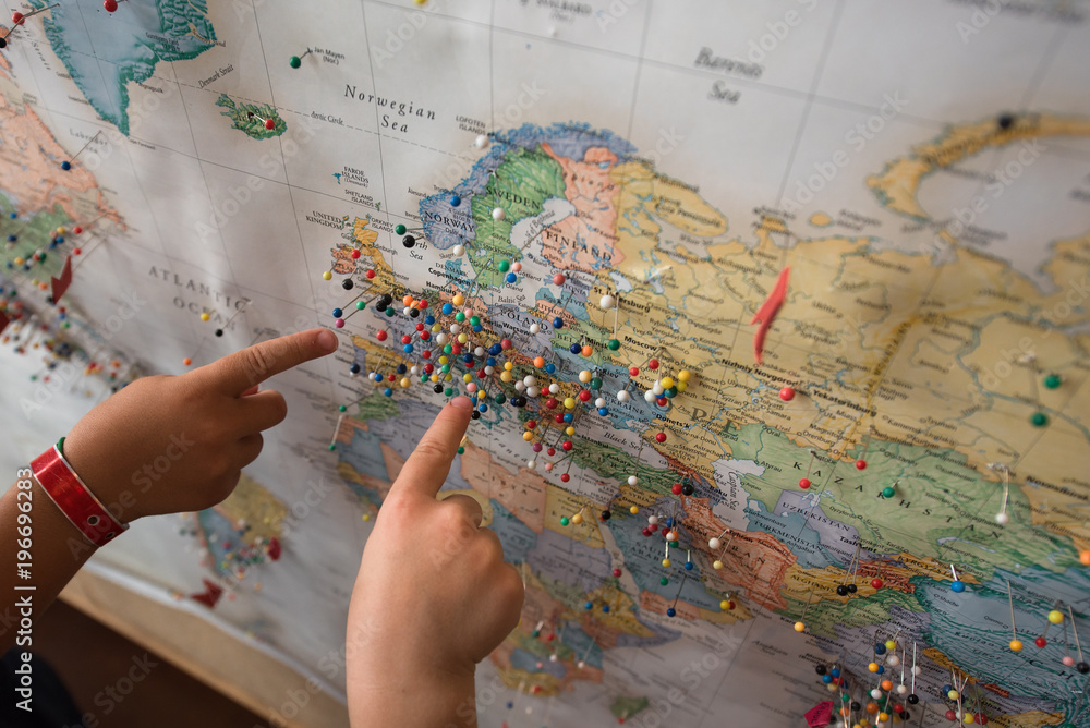 Children pointing at map with pins Stock Photo | Adobe Stock
