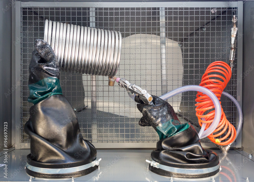 Sandblasting of a heat exchanger inside a special cabin. Stock Photo ...