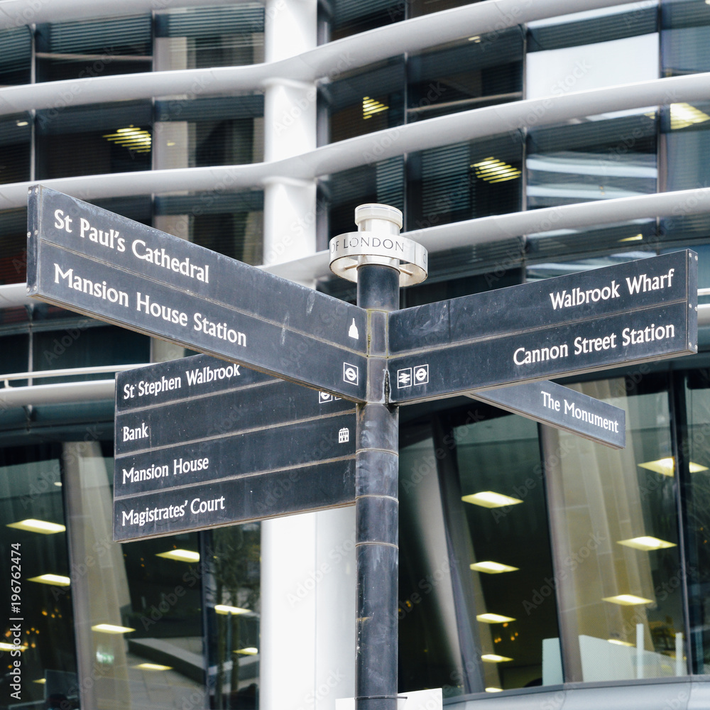 Signpost in the City of London, England, UK pointing to various ...