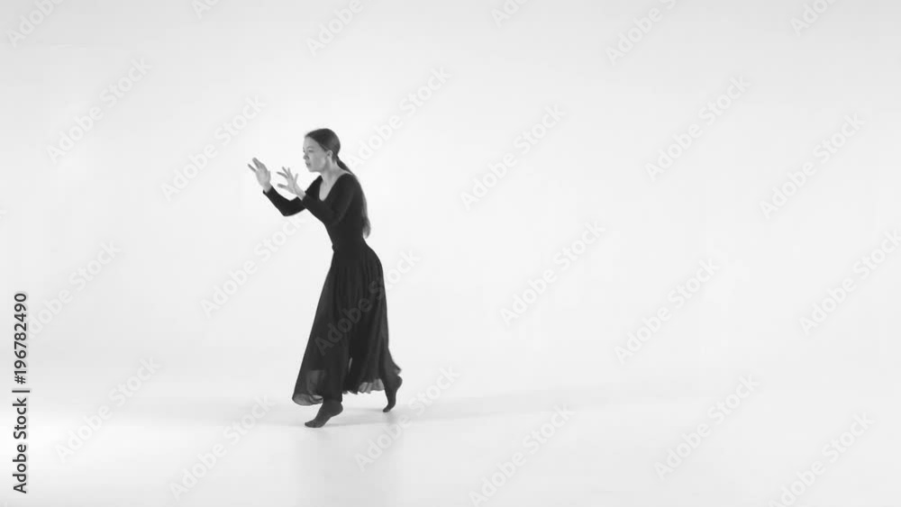 Black and white image. Young woman choreographer dancing in a black ...