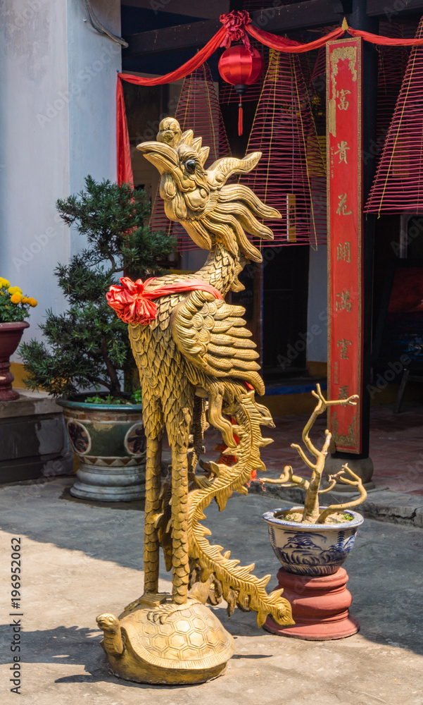brass statue of a phoenix standing on a turtle: two common animals seen ...