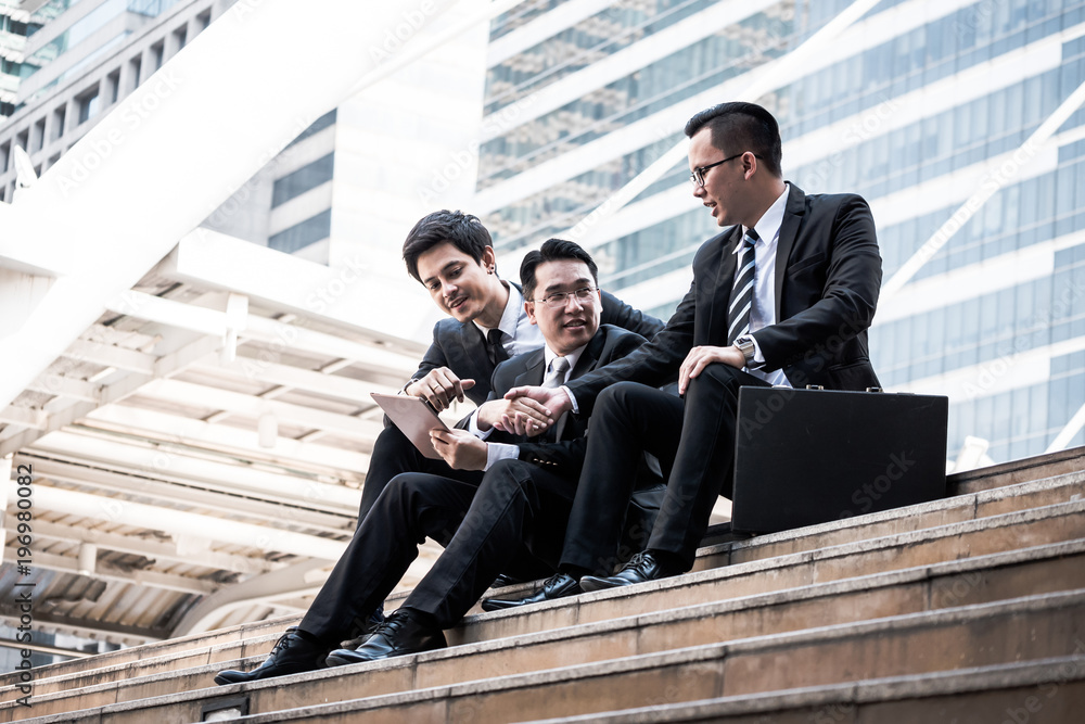 Cheerful group of young business men shaking hands together after new ...