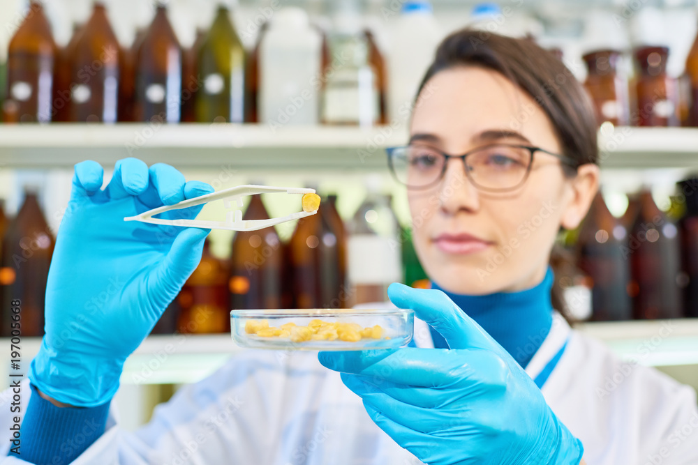 Head and shoulders portrait of dark-haired young scientist wearing ...