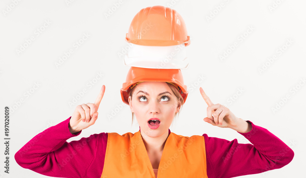 Woman with surprised, confused face pointing at head, white background ...