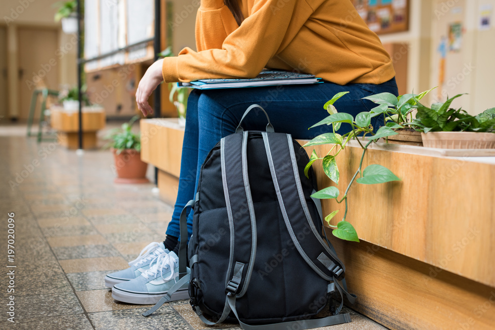 Young unrecognisable depressed lonely female college student sitting in ...