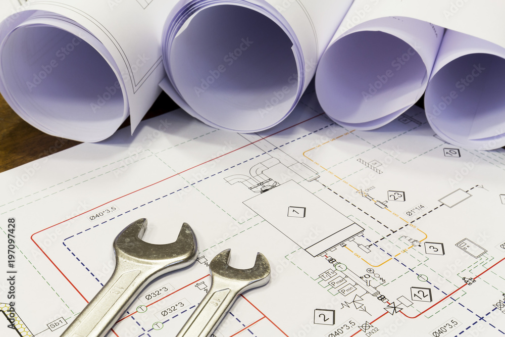 Maintenance and service: Wrench and project drawings with plumbing ...