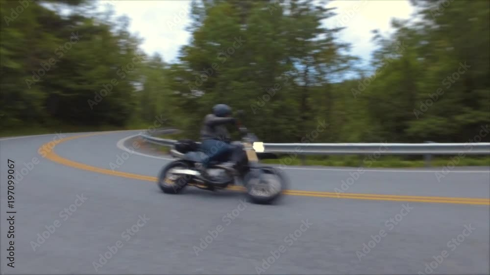 motorcycle rider takes corner fast and leaning hard with leg out for ...