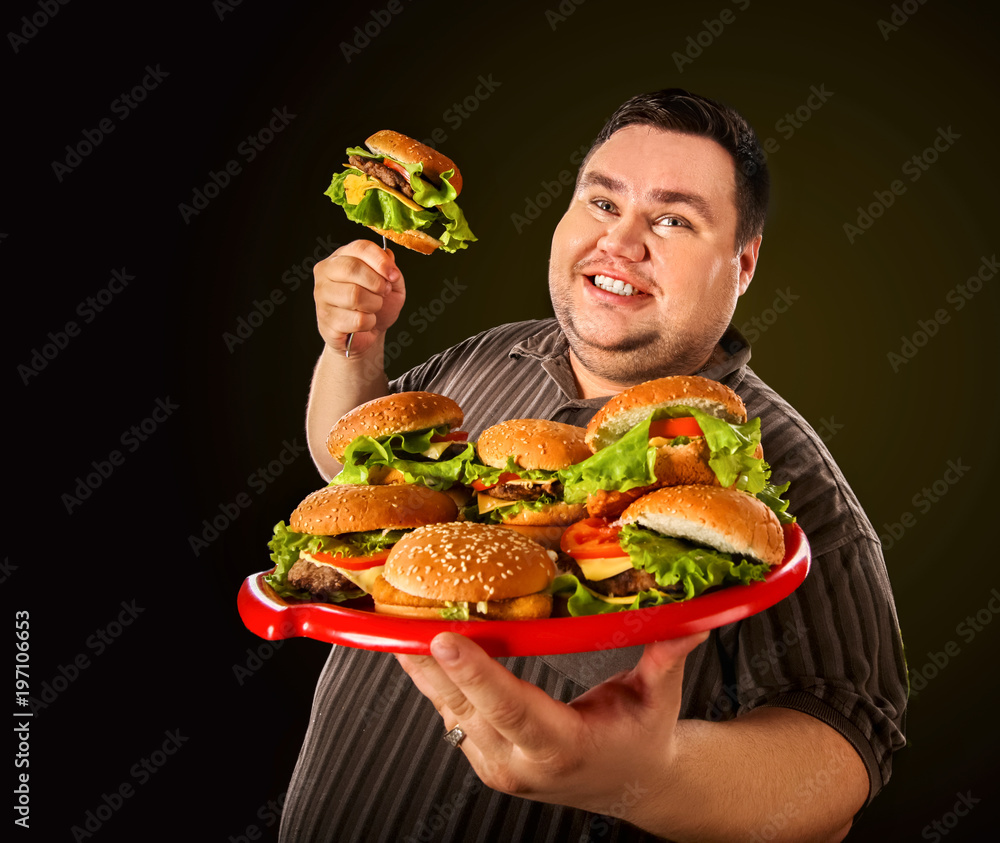 Fat man eating fast food hamberger and carries treat for friends on ...
