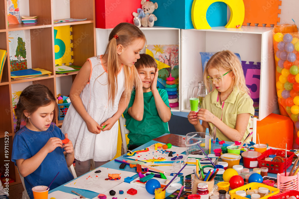 Plasticine modeling clay in children class. Teacher teaches kids ...