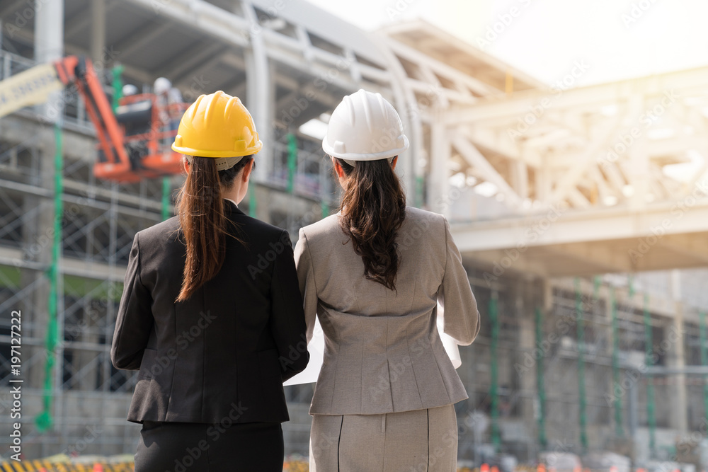 Girl architect looking at building project. Stock Photo | Adobe Stock