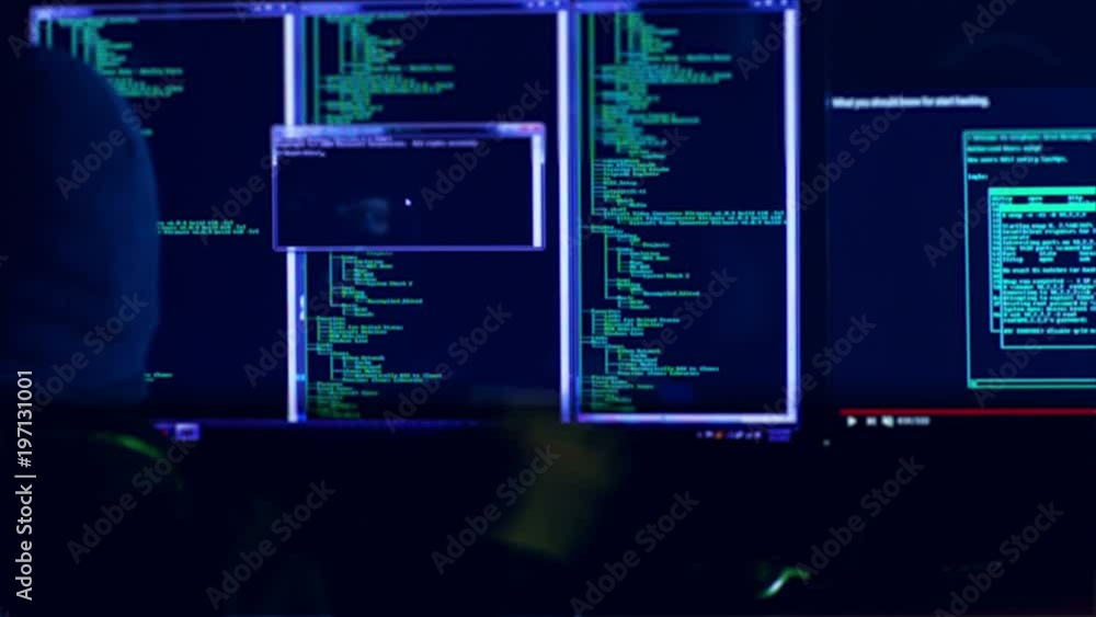 Hacker with mask breaking code. Hacker with mask using computers to crack the internet from ...