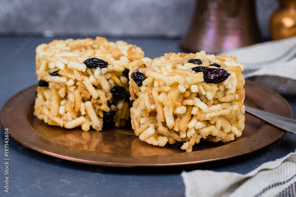 Eastern or Asian sweets (chak-chak) with honey, raisins and walnut on ...