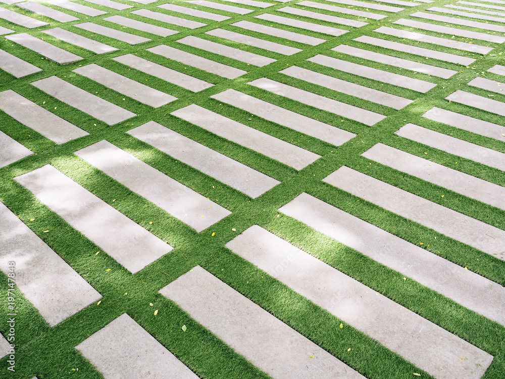 Cement block path walkway on green grass background Stock Photo | Adobe ...