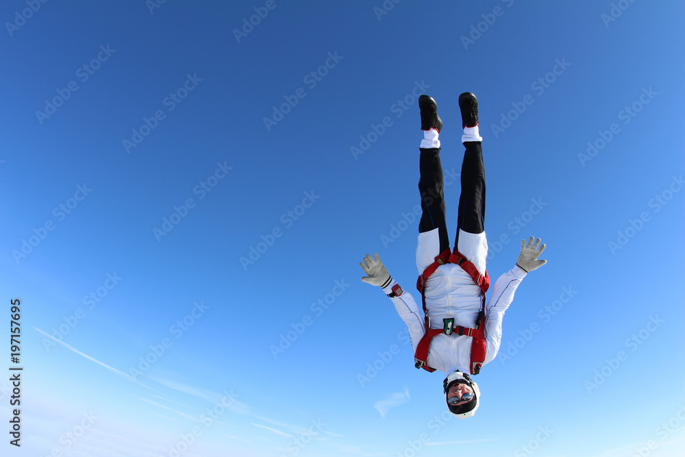 Skydiver is flying head down position. Stock Photo | Adobe Stock
