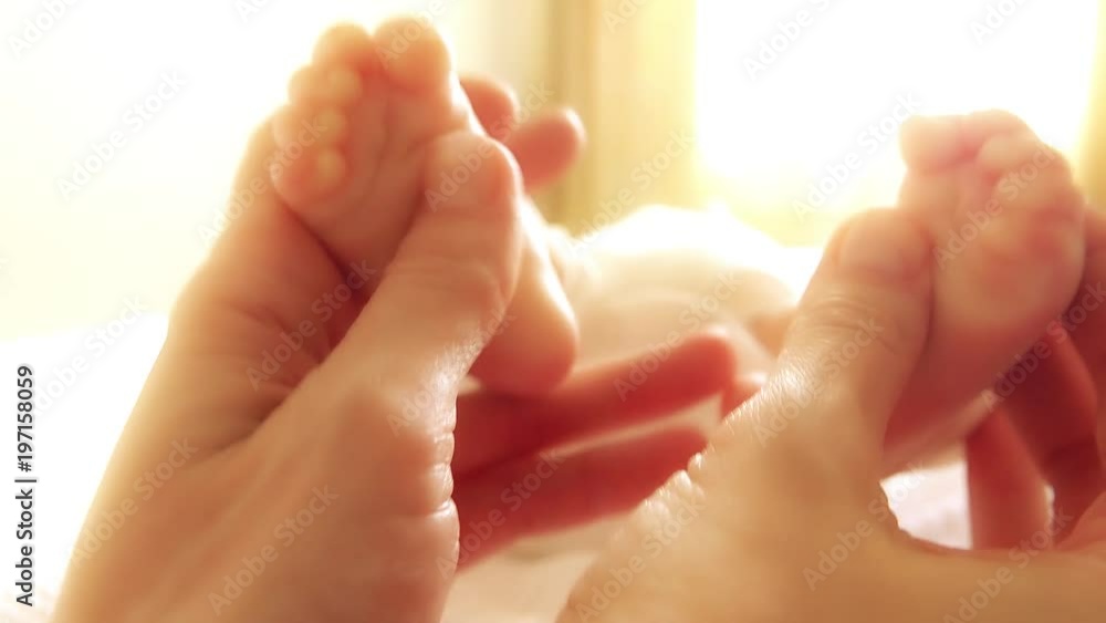 Mother tickling newborn baby's feet Stock Video | Adobe Stock