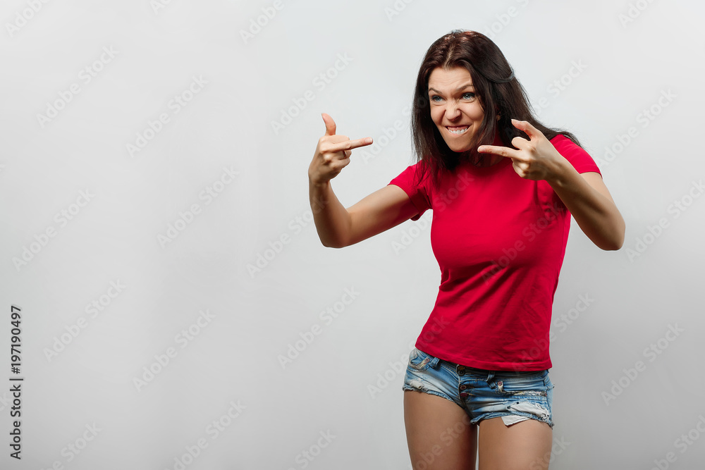 Young, beautiful girl showing the middle finger. Isolated on a light ...