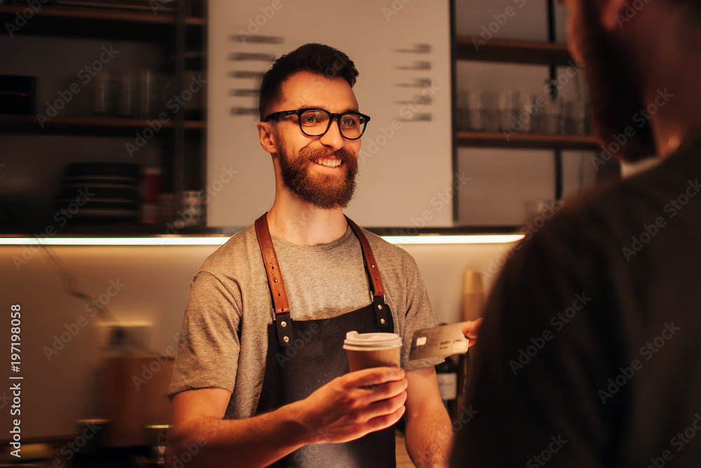 A picture of bearded hipster barmen that wears glasses standing behind ...