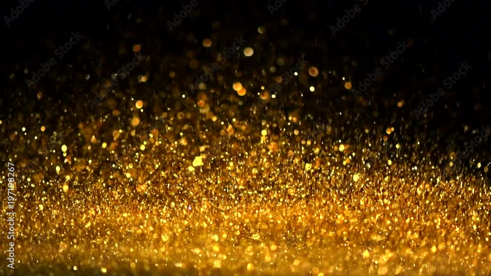 Glitter exploding golden sparkles isolated on black background ...