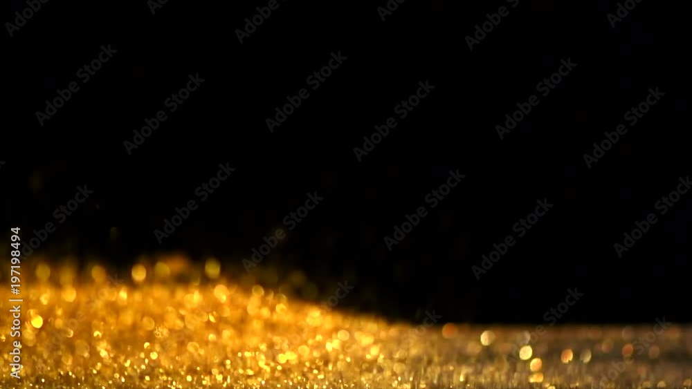 Glitter exploding golden sparkles isolated on black background ...