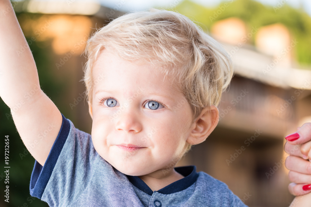 Little Boy With Blonde Hair And Blue Eyes