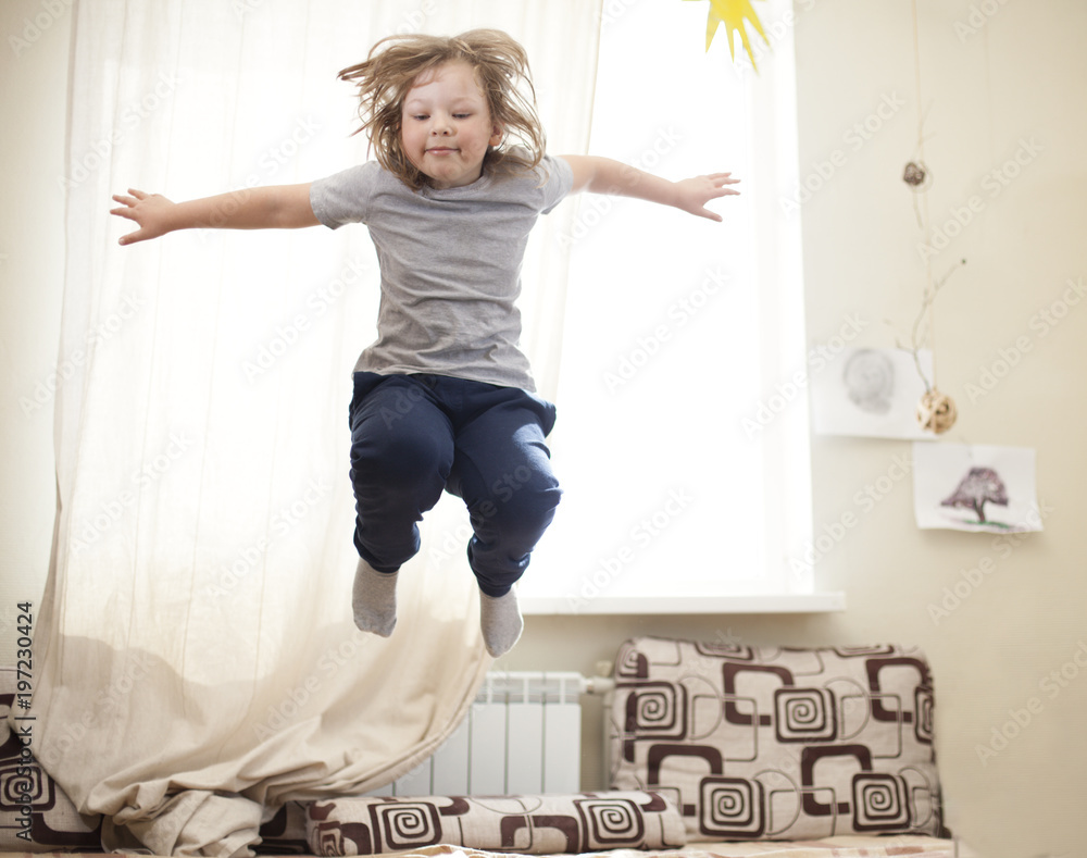 child jumping on the bed in the bedroom Stock Photo | Adobe Stock