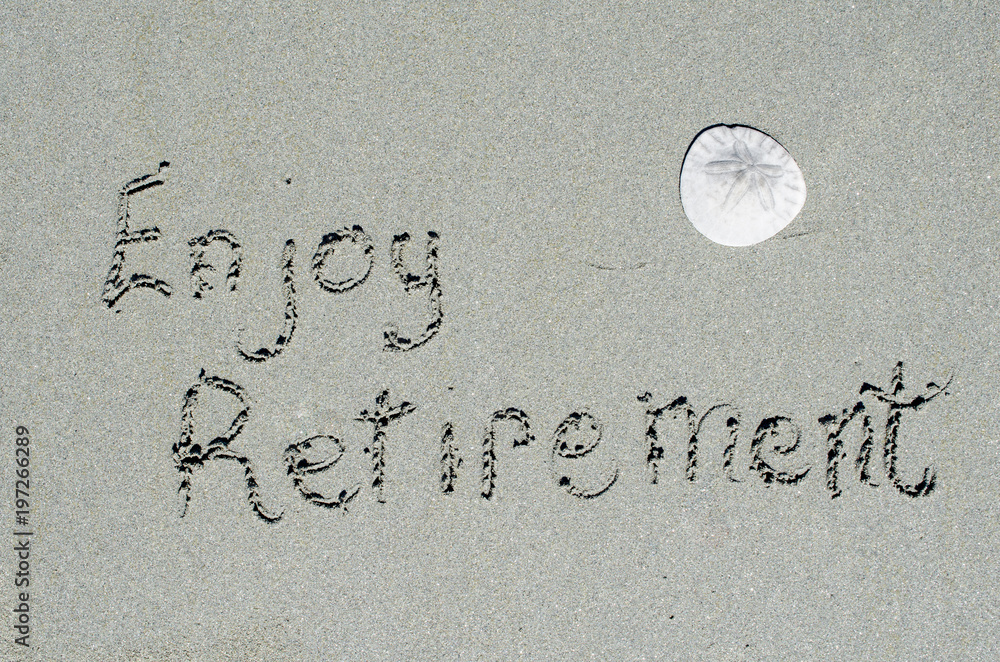 Enjoy retirement written in ocean beach sand. Concept of fun and ...