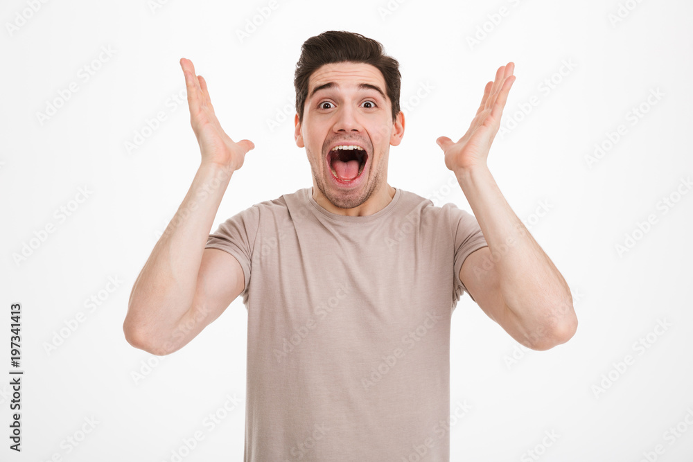Photo of young unshaved guy with exciting facial expressions shouting ...