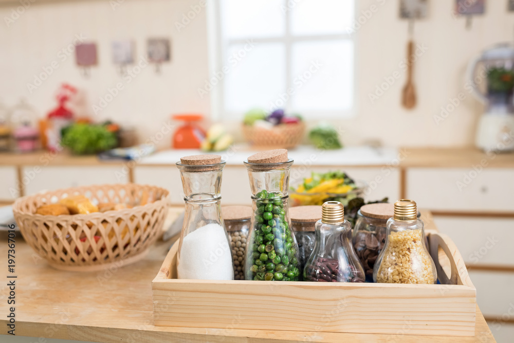 Condiment set ingredients placed on table with on blur kitchen ...