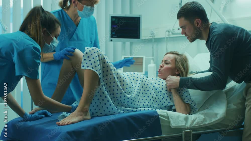 In the Hospital, Woman in Labor Gives Birth, Obstetricians and Doctors ...