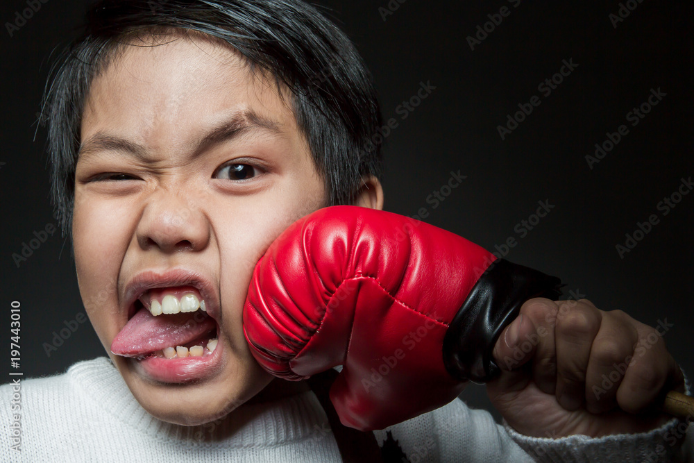 Happy chinese boy getting a hard punch from boxing glove fist. Stock ...