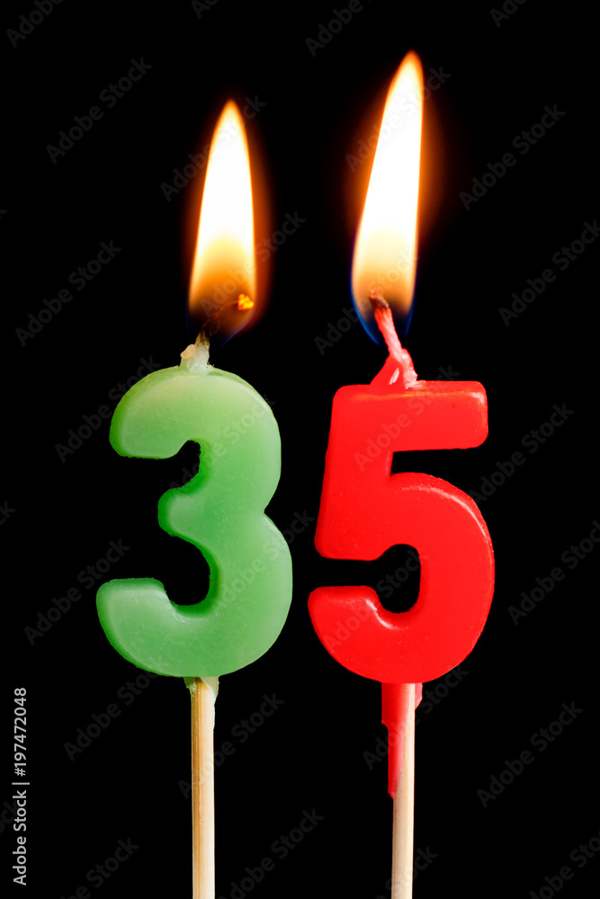 Burning candles in the form of 35 thirty five figures (numbers, dates ...