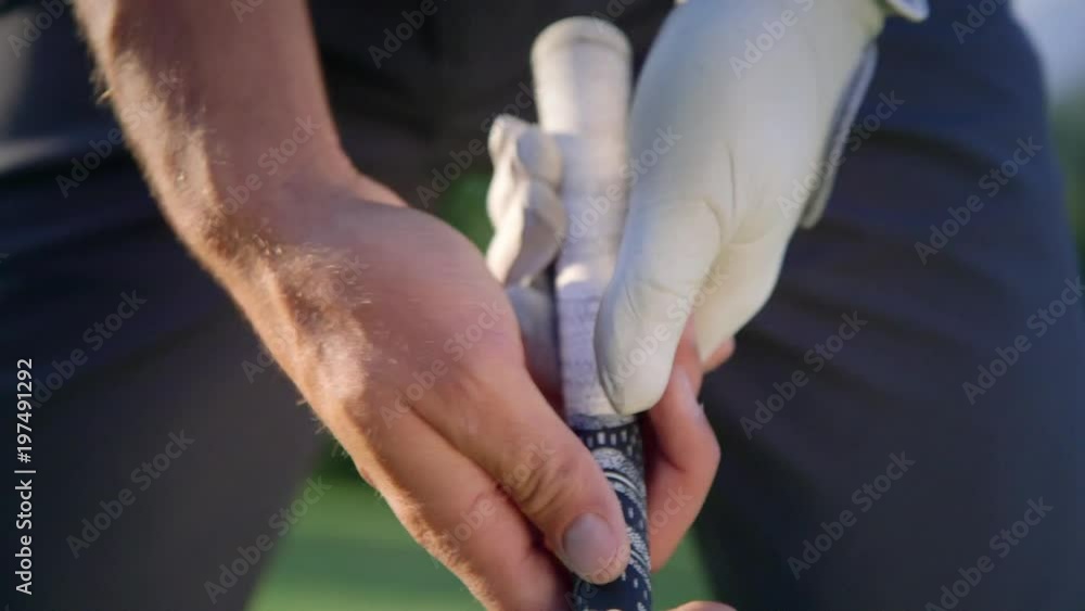 Pro golfer, perfect grip. Pro golfer holding his club, adjusting the ...