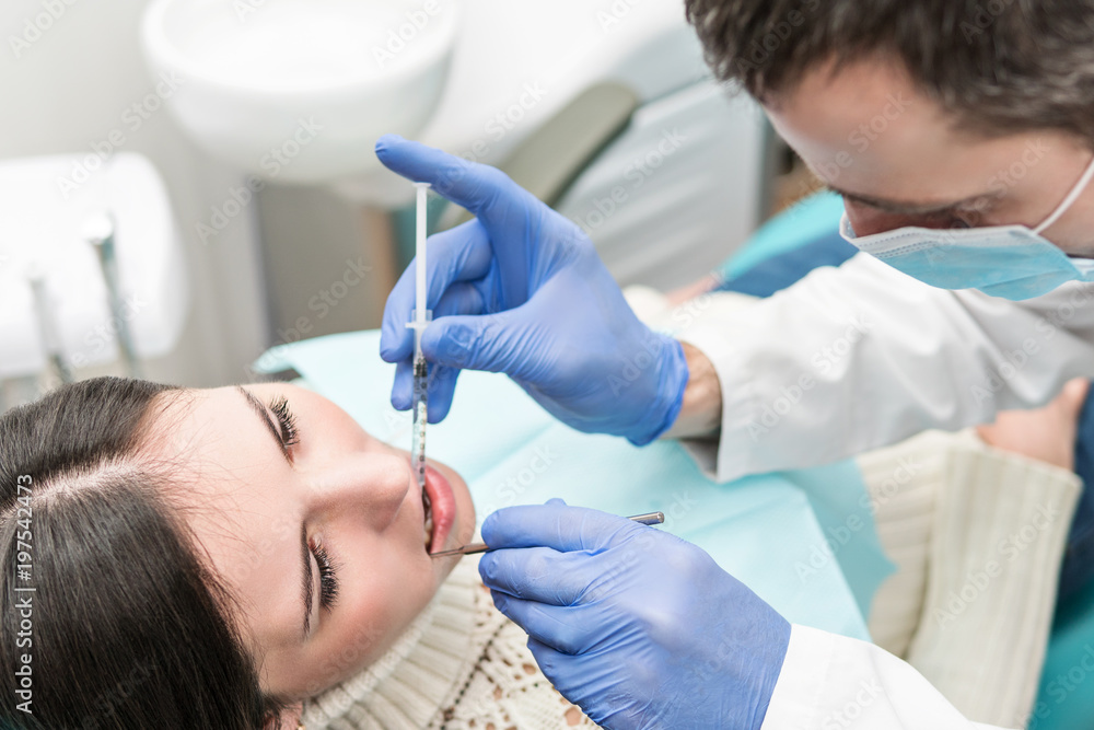 Dentist makes an anesthetic injection for the patient Stock Photo ...