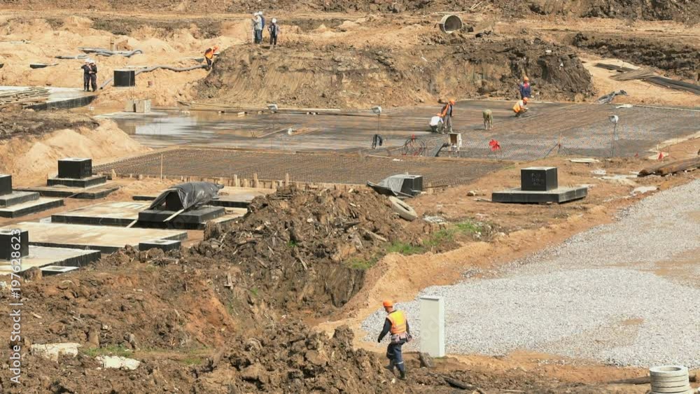 Building large complex and laying the foundation. Brigade of builders ...