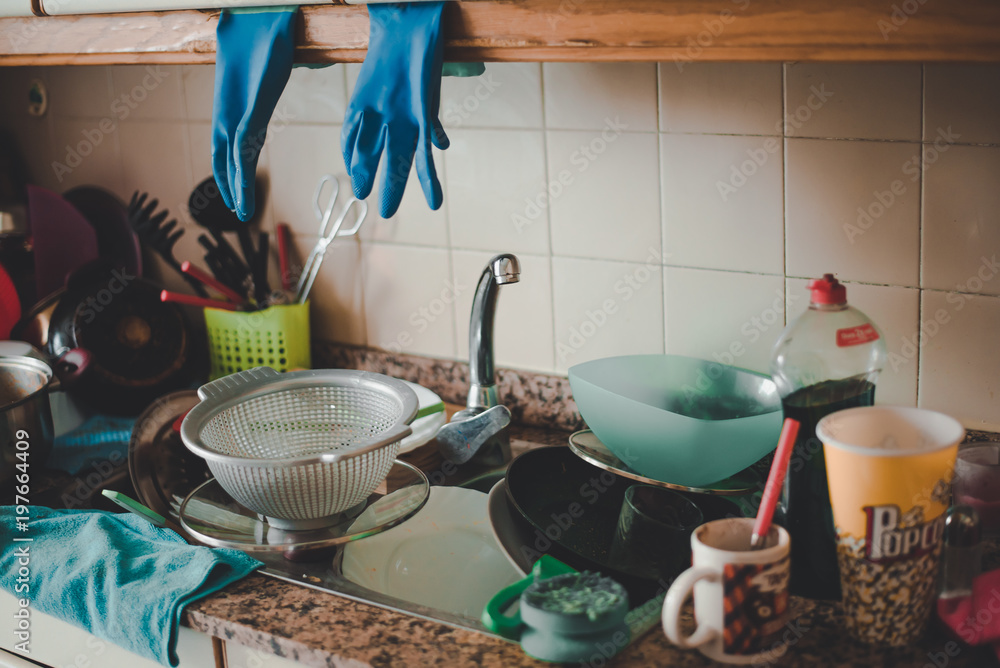 Messy countertop with dirty dishes in the sink Stock Photo | Adobe Stock