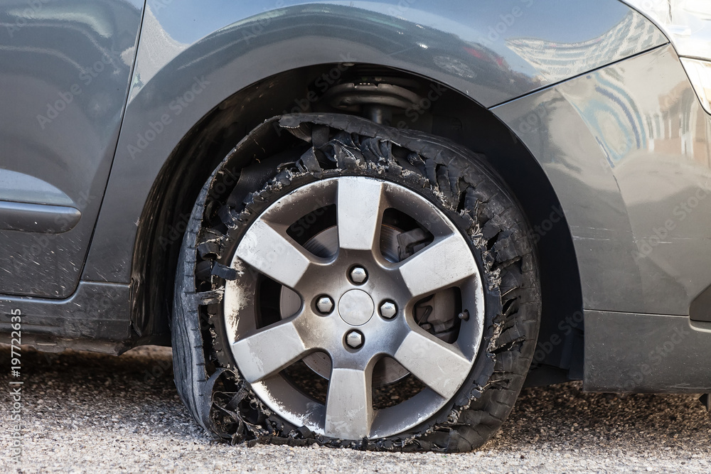 Destroyed blown out tire with exploded, shredded and damaged rubber on ...