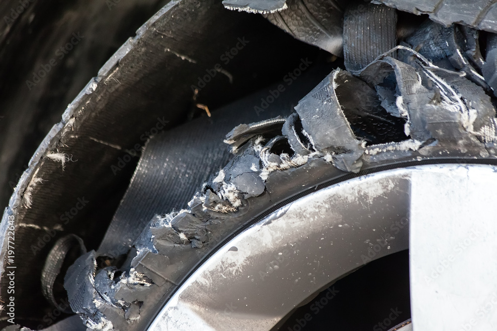 Close up details of a blown out tire with exploded, shredded and ...