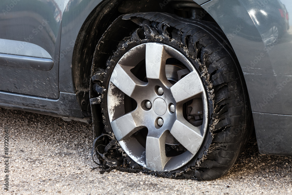 Destroyed blown out tire with exploded, shredded and damaged rubber on ...
