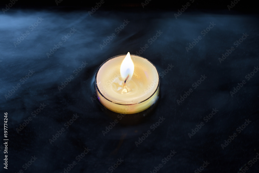 "Reflections" a single votive candle in a deep dark reflecting pool ...
