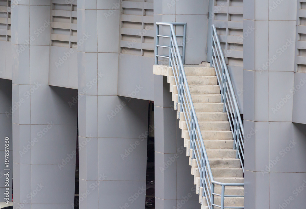 fire exit concrete stair outside the building with blue steel handrail ...