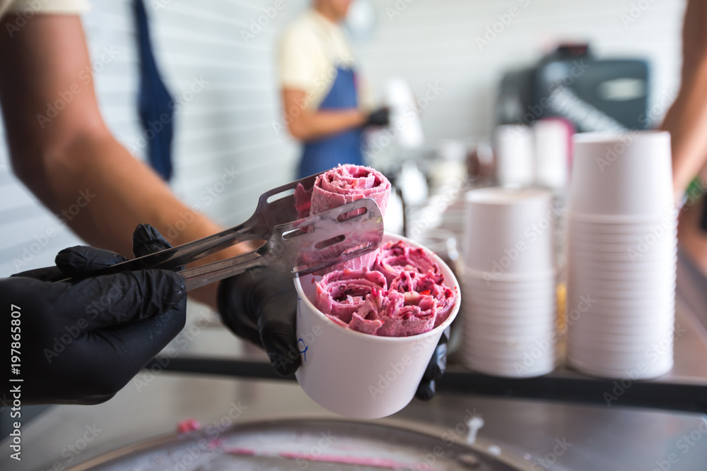 Stir-fried ice cream rolls at freeze pan. Rolled ice cream, hand made ...