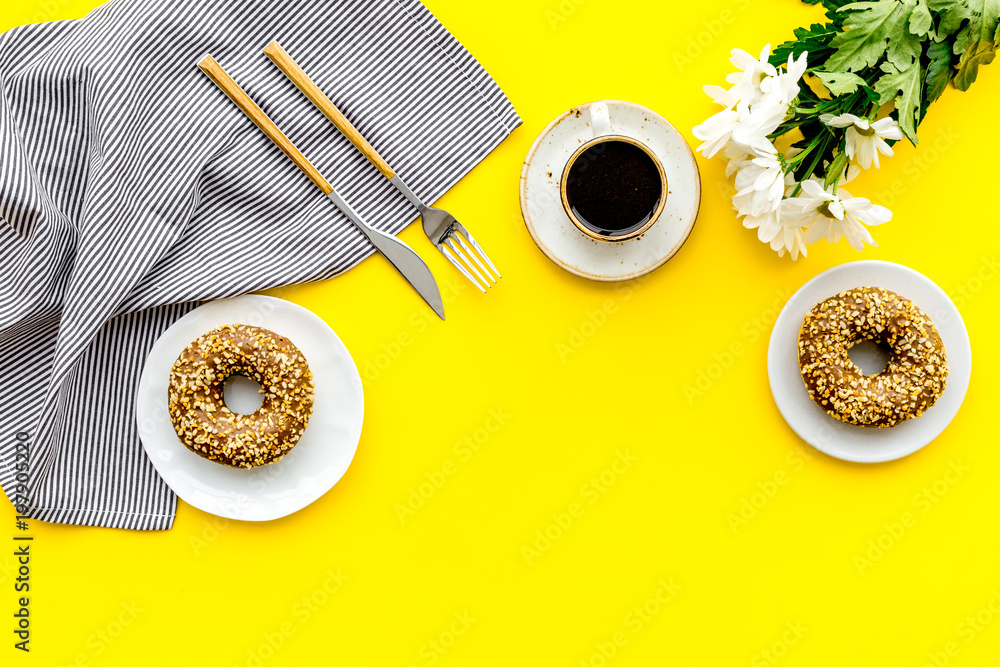 woman desk with flowers, coffee and donuts for breakfast in spring ...