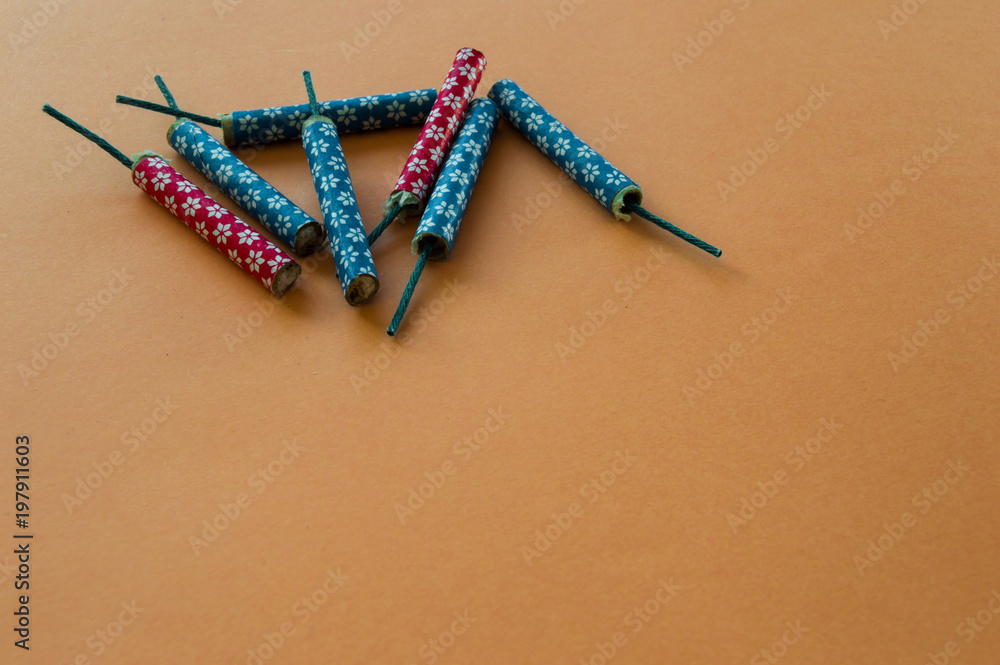 Pretty red and blue firecrackers isolated on orange background. Stock ...