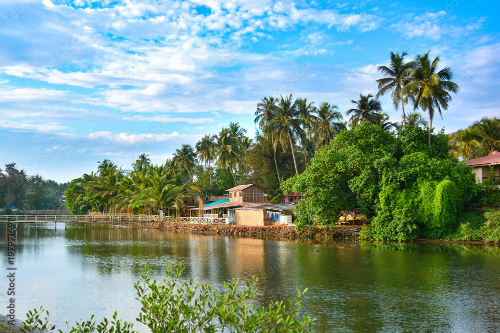 River on the beach in Mandrem with views of buildings in North Goa ...